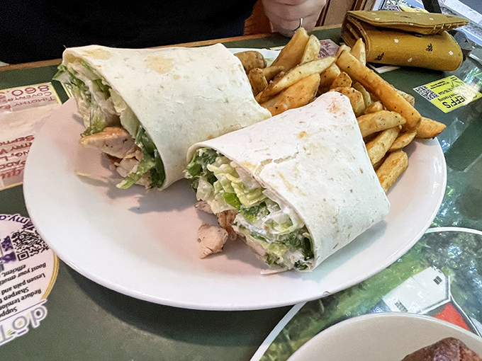 The wrap that launched a thousand road trips. Crisp lettuce, tender chicken, and a perfect tortilla hug – served with golden fries that demand to be stolen one by one.