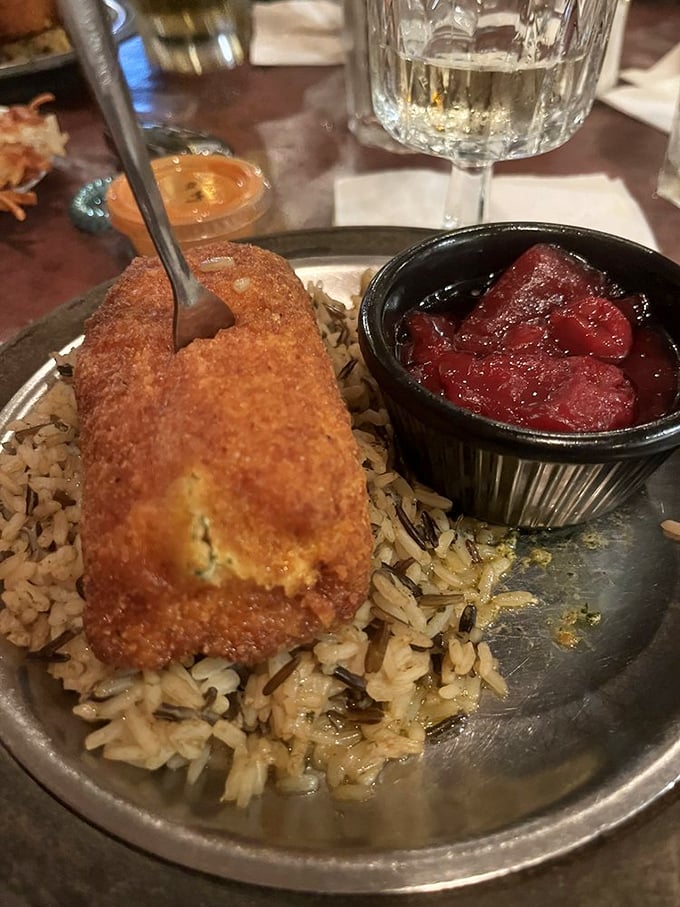 Crispy on the outside, bursting with buttery goodness inside—this chicken Kiev sits on a bed of wild rice like royalty on a throne.