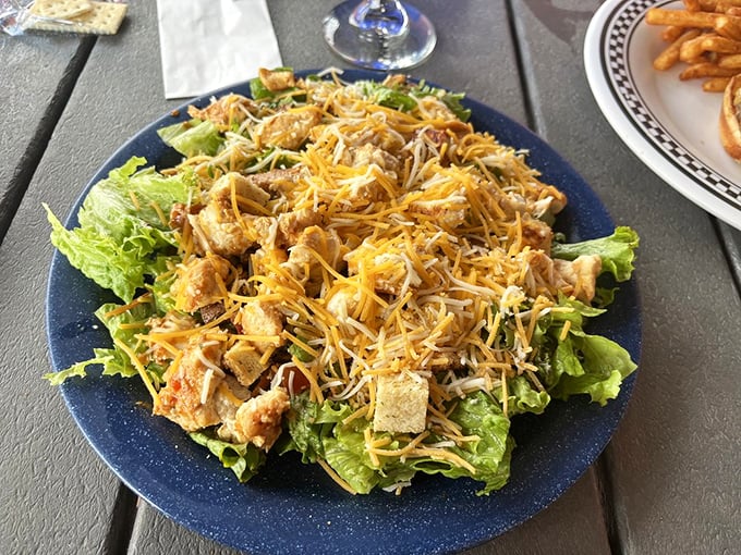 Fresh greens playing host to seasoned chicken and shredded cheese—proof that salads don't have to be boring to be called salads.