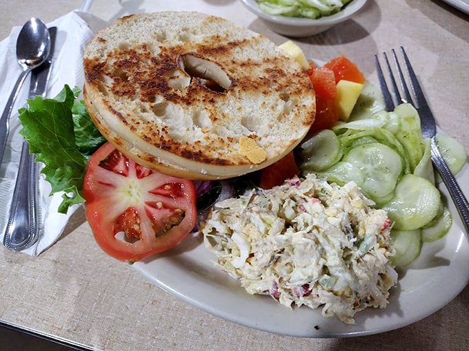 A proper bagel with chicken salad and fresh vegetables—proof that sometimes lunch should be both virtuous and delicious without sacrificing either.