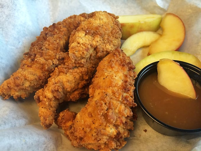 Chicken strips that redefine the category—juicy inside, audibly crunchy outside, served with fresh apple slices for that hint of wholesomeness.