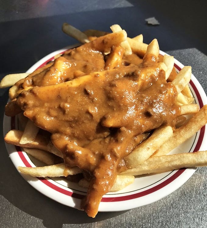 Chili cheese fries that don't mess around—a plate of golden potatoes smothered in savory chili that's worth every napkin you'll need afterward.