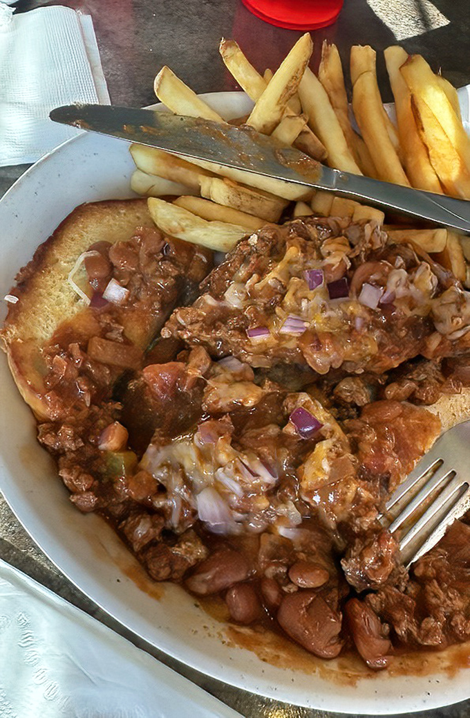 Not just chili on a burger—it's a soulful symphony of beef, beans, and melted cheese that makes fast food chains weep with inadequacy.