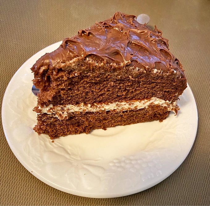 A slice of chocolate cake so rich and decadent it deserves its own tax bracket.