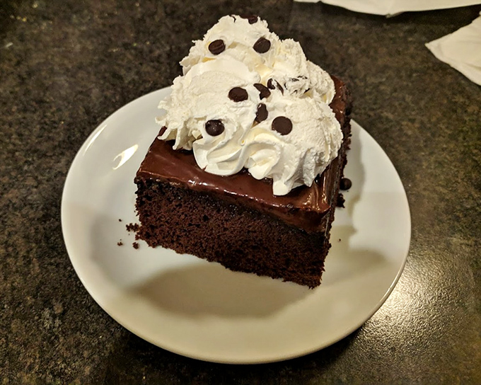 This chocolate cake doesn't need a fancy French name to tell you it's magnificent—the whipped cream and chocolate chips speak volumes.