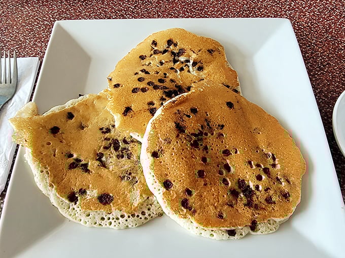 Chocolate chip pancakes that don't just have chips, but seem to have had a meaningful relationship with chocolate—fluffy, golden, and perfectly spotted.