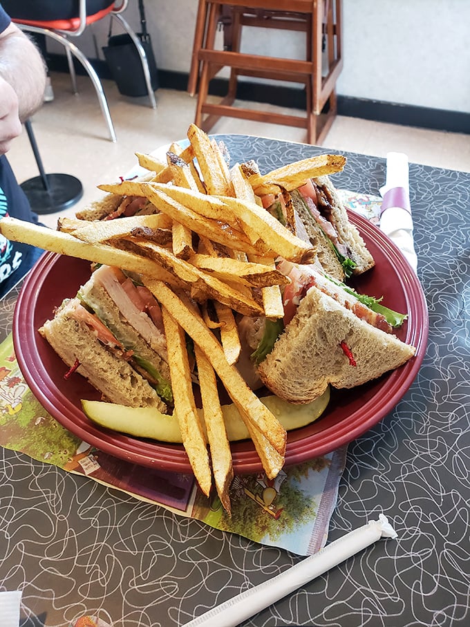 The club sandwich: architectural marvel of the diner world. Those perfectly golden fries aren't just sides—they're supporting actors deserving their own award.