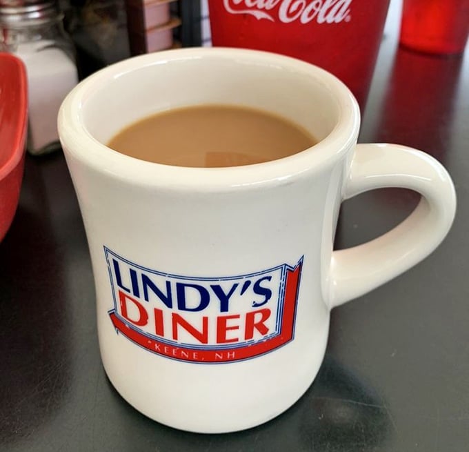 That sturdy diner mug isn't just holding coffee; it's cradling liquid optimism that tastes better with every contemplative sip.