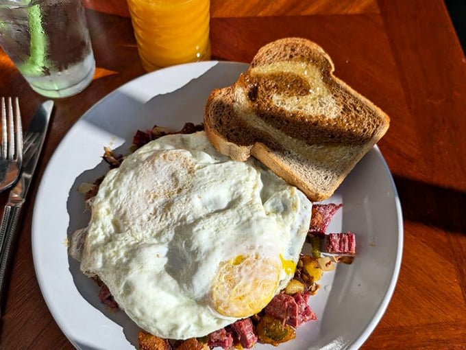 Corned beef hash topped with eggs that look like they're wearing sunny-side-up halos. This plate is what breakfast dreams are made of.