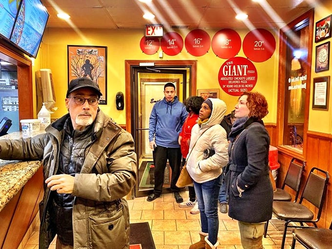 The waiting area at J.B. Alberto's—where strangers united by hunger become comrades in the noble pursuit of pizza.