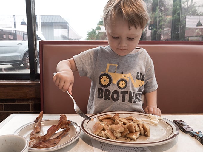 Even the youngest diners understand the sacred ritual of breakfast. That look of concentration says, "These pancakes aren't going to eat themselves." 