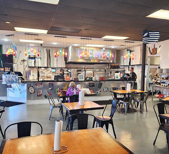 The counter view reveals the beating heart of Lucino's – where pizza dreams come to life under colorful pendant lights and watchful expertise.