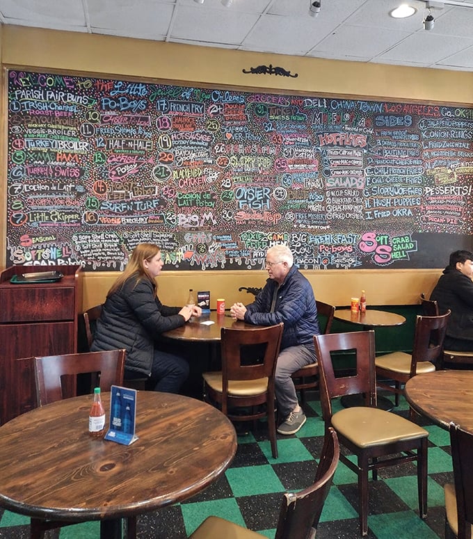 Against a backdrop of colorful menu art, diners share stories and bites—proof that great food creates its own community, even 1,900 miles from the source.