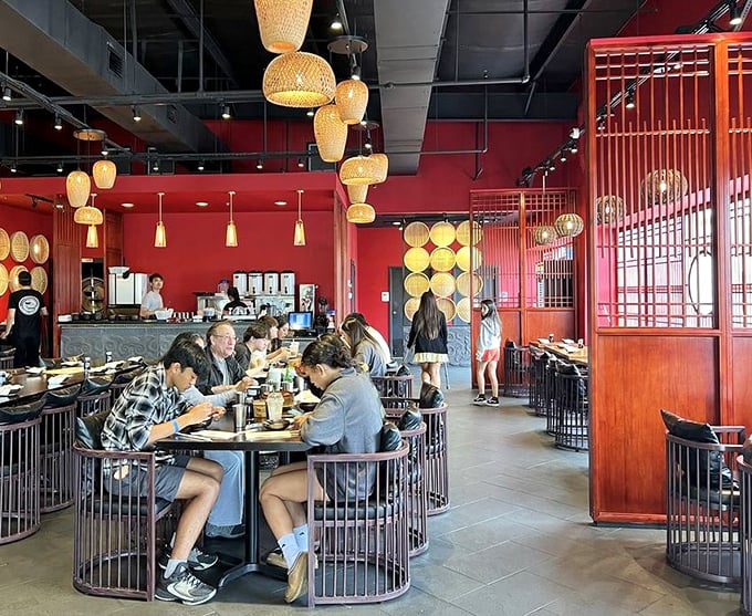 The circular booth seating creates little islands of conversation and shared plates – dining as it should be, communal and joyful.