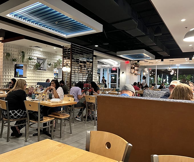 Even on busy nights, Agave Azul's dining room buzzes with energy as patrons dive into authentic Mexican cuisine under the restaurant's signature blue lighting.