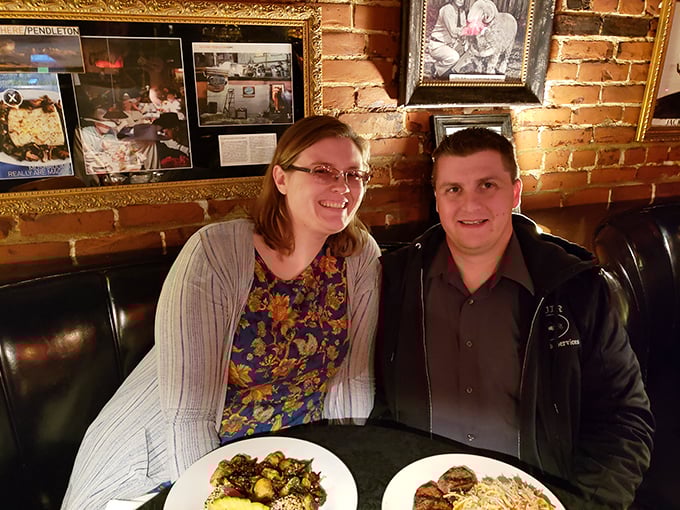 The brick wall backdrop and cozy booth create the perfect setting for making memories over meals that matter.