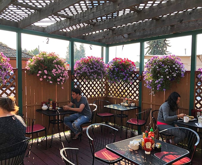 The outdoor patio—where hanging flowers create nature's chandelier and breakfast conversations flow as easily as the coffee refills.