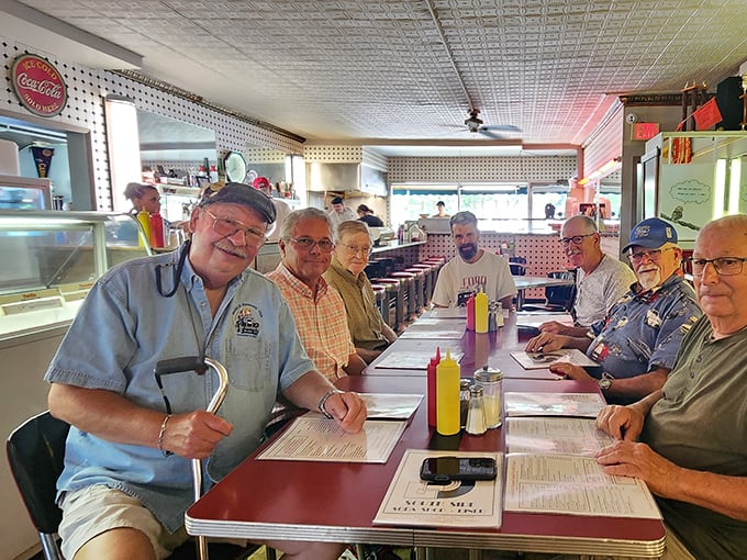 The counter crew—regulars who've turned daily visits into a community tradition. Their laughter and stories are as much a part of the place as the pressed tin ceiling.