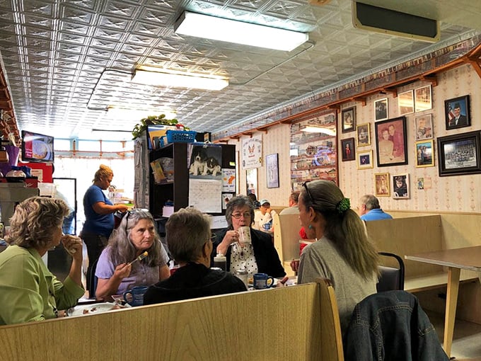 Regulars gathered in booths beneath that classic tin ceiling, proving breakfast tastes better with good company nearby.