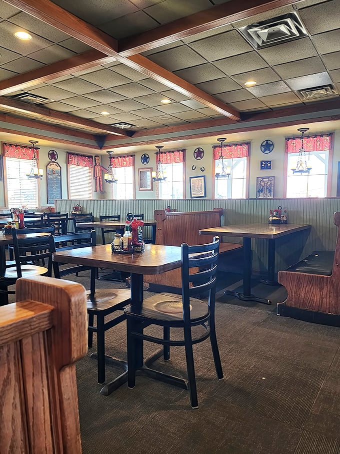 Empty tables waiting for the lunch rush like actors before curtain call – each wooden booth holding decades of local stories.