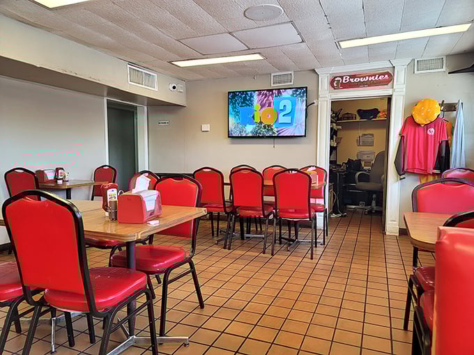 Red chairs against terra cotta tiles—Brownie's dining room isn't trying to be Instagram-famous. It's too busy being authentically, unapologetically itself.