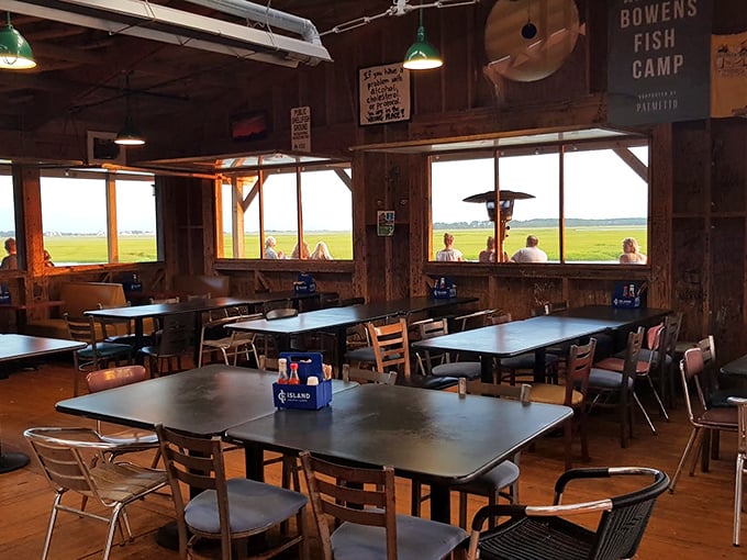 Simple tables, wooden walls, and windows framing the marshland—dining rooms don't get more honestly Lowcountry than this.