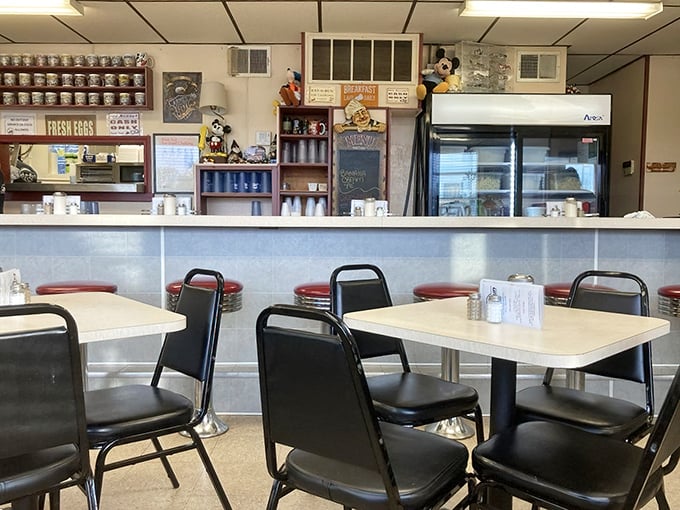 Mickey Mouse collectibles watch over diners from their perch above the counter – unexpected whimsy in this temple of serious eating.