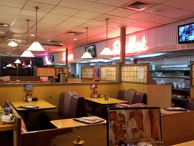 Cozy booths bathed in warm light invite lingering conversations. This isn't just a place to eat – it's where memories are made.