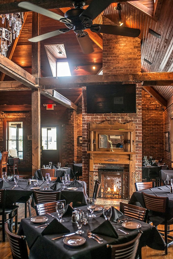 Fireplace, exposed brick, and tables set for culinary adventure. The dining room feels like the living room of that friend who's a much better cook than you.