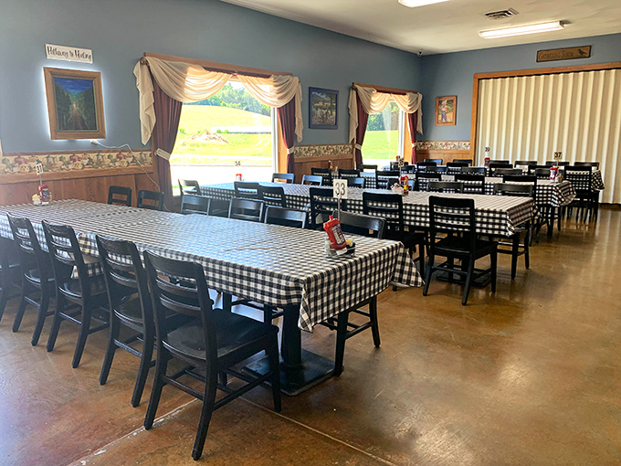 Black and white checkered tablecloths against blue walls—the dining room equivalent of a warm hug from someone who knows how to cook.