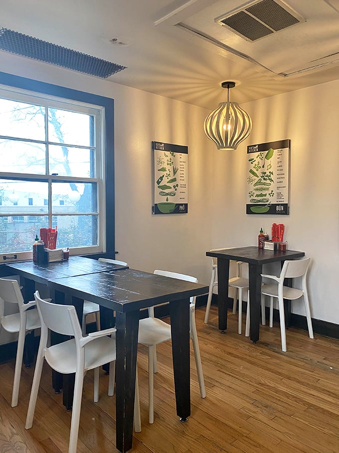 Simple wooden tables and bright windows create a dining space where conversations flow as easily as the Vietnamese iced coffee.