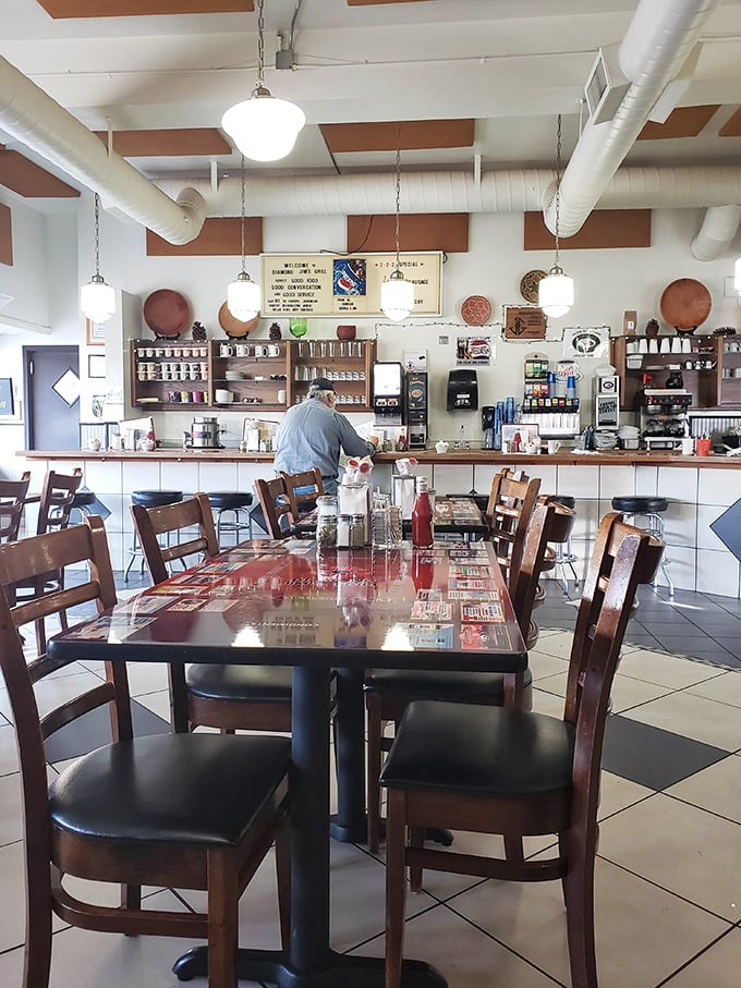 Classic diner charm with checkered floors and wooden chairs – where conversations flow as freely as the coffee refills.