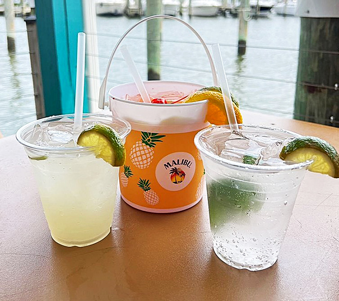 Colorful cocktails with a waterfront view—because nothing complements crab like something cold, fruity, and strong enough to make you forget the mess you're making.