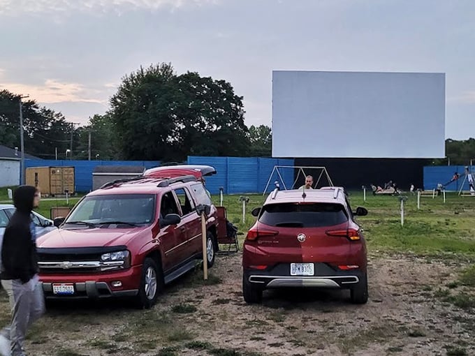 Cars arranged with military precision, each a private theater box where you can laugh loudly or cry quietly without judgment.
