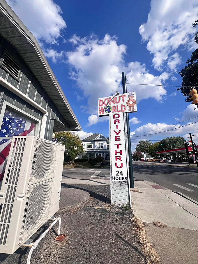 The iconic Donut World sign against a perfect blue Ohio sky—a siren call to carb enthusiasts and a landmark for locals in the know.