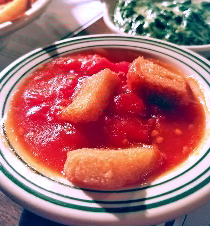 The famous stewed tomatoes – sweet, tangy, and somehow transformative – proof that side dishes can be memorable characters, not just extras.