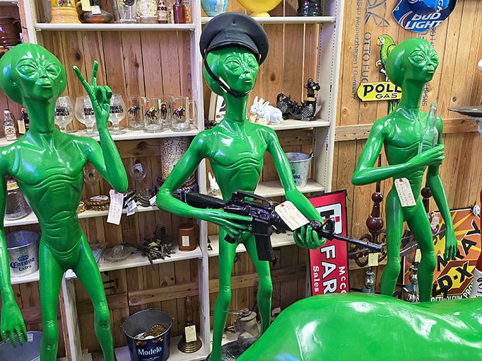 The alien welcoming committee stands ready with peace signs and... automatic weapons? The '90s were a confusing time for extraterrestrials.