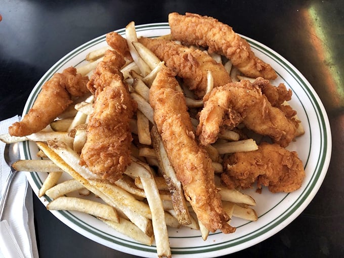 Fish and chips that would make a British pub jealous. Those golden-battered treasures aren't just fried—they're transformed into crunchy vessels of joy atop a bed of perfect fries.