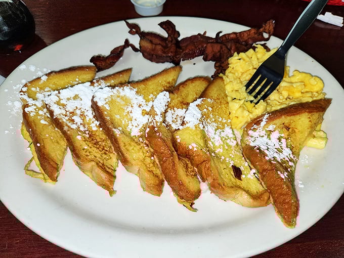 French toast that puts France on notice. Dusted with powdered sugar and served with crispy bacon—breakfast harmony achieved.