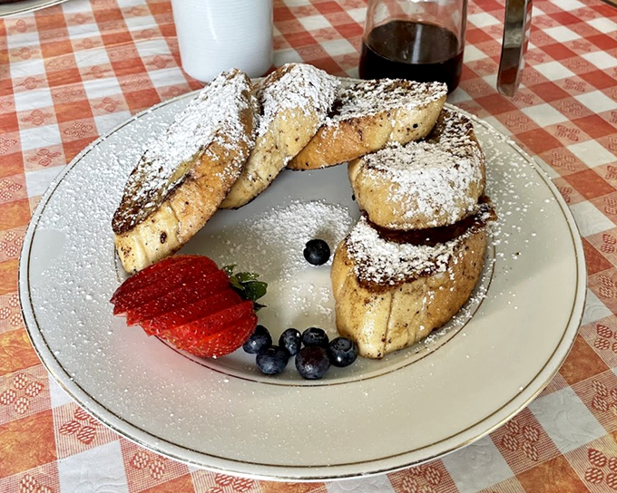 French toast that's been properly introduced to powdered sugar and fresh berries—a breakfast triple threat.