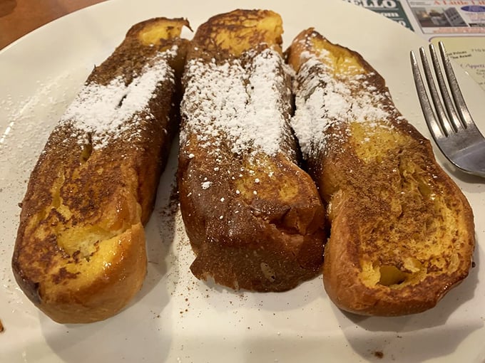 French toast that's crossed the line from breakfast to dessert, with a dusting of powdered sugar that makes every bite feel like a celebration. Morning decadence at its finest.