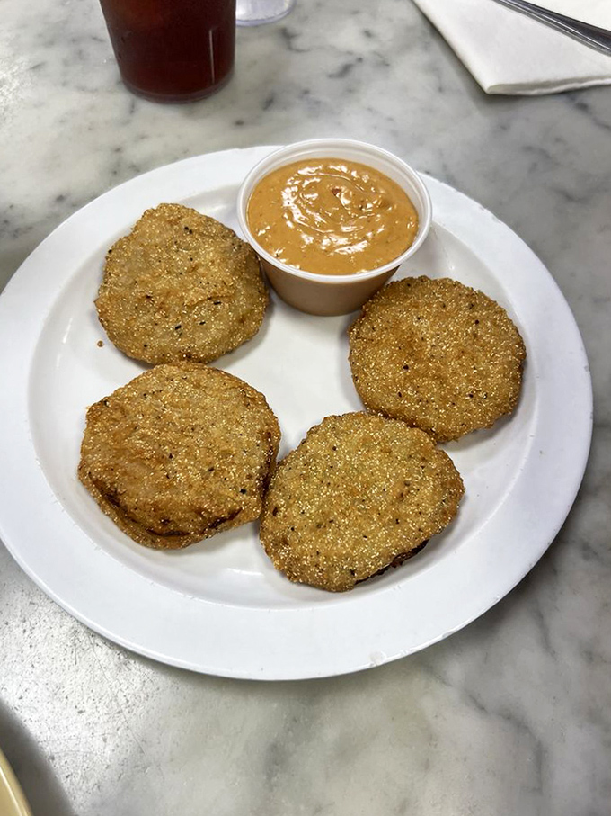 Fried green tomatoes—tangy slices wearing crunchy golden jackets, ready to dip into that creamy sauce like they're heading to a Southern pool party.