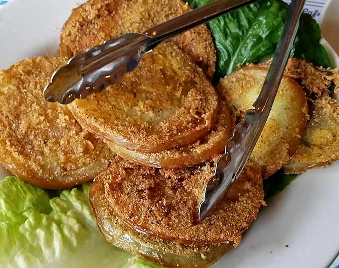 Fried green tomatoes – the South's gift to the culinary world. Tangy slices transformed into crispy, golden discs that disappear faster than summer lightning.