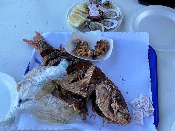 This whole fried fish stares back as if to say, "Worth it"—crispy on the outside, flaky and moist within, served with the simplicity that only confidence allows.
