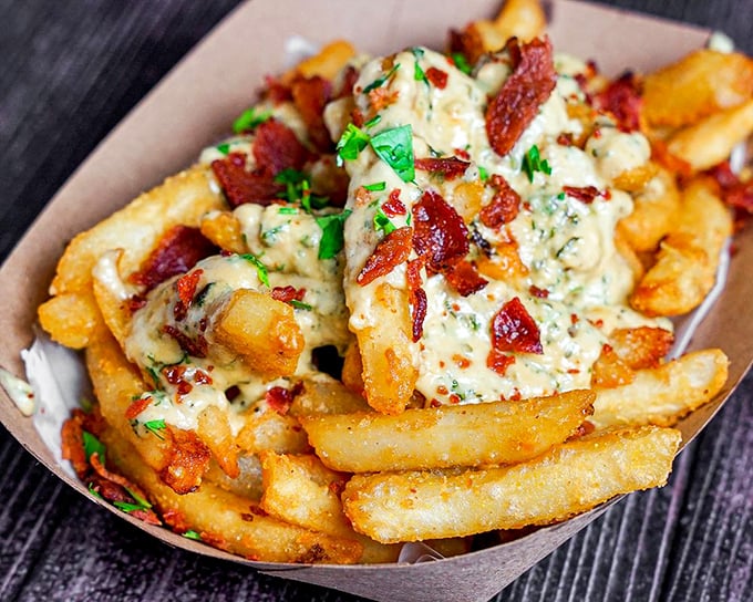 These aren't just cheese fries—they're a masterpiece of crispy potatoes, melted cheese, and bacon that would make Michelangelo weep.