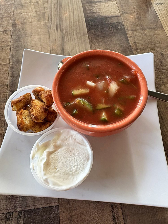 A vibrant gazpacho with perfectly diced vegetables and a side of croutons—summer in a bowl, even when Florida's thermometer is breaking records.