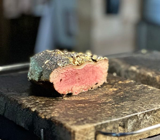 That perfect pink center surrounded by a seasoned crust isn't just steak—it's edible evidence that patience and fire create miracles.