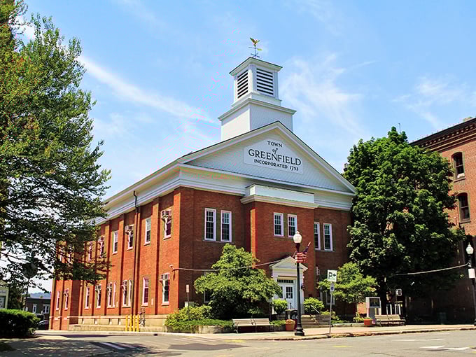 Greenfield's City Hall stands proudly with its brick façade and white cupola—civic architecture from when government buildings weren't just concrete rectangles.