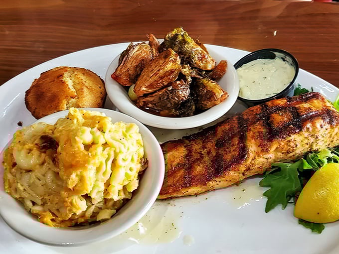 Grilled salmon keeping company with Brussels sprouts and mac and cheese – healthy meets indulgent in perfect harmony.