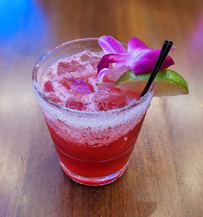This vibrant hibiscus cocktail doesn't just look Instagram-worthy – it tastes like summer vacation in a sugar-rimmed glass.
